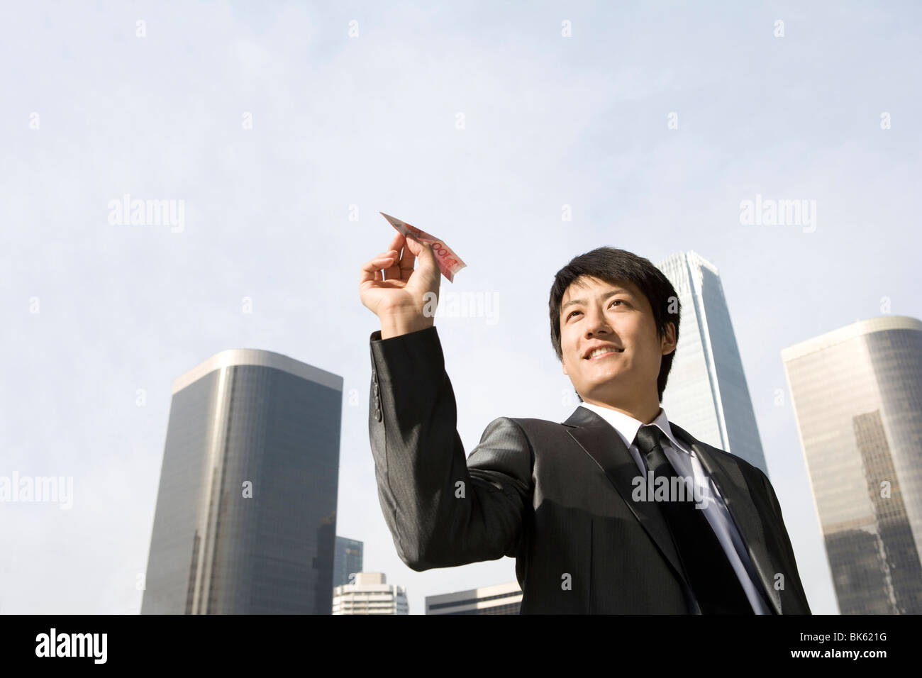 Businessman Flying RMB Paper Airplane Stock Photo - Alamy