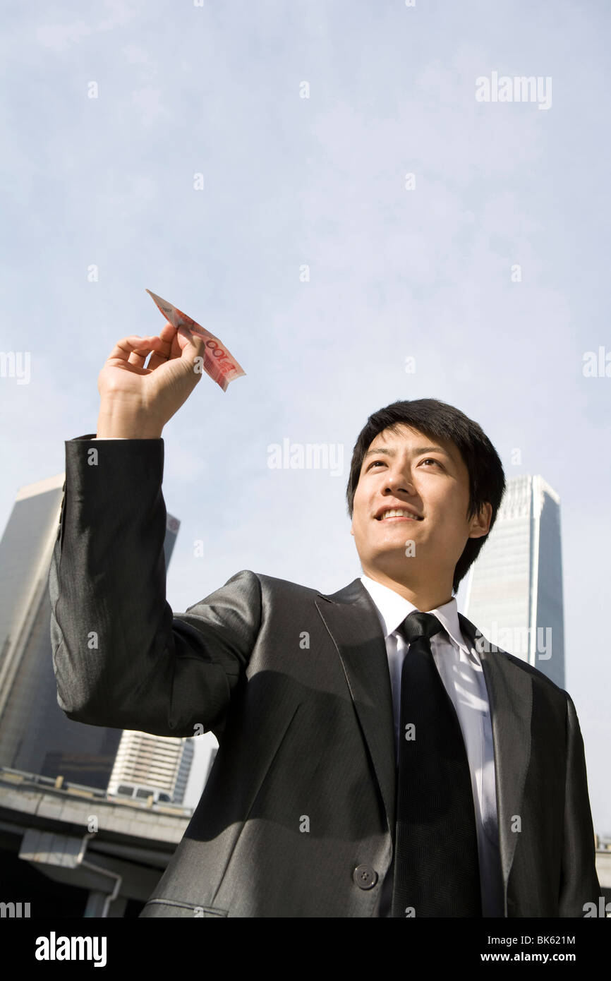 Businessman Flying RMB Paper Airplane Stock Photo - Alamy