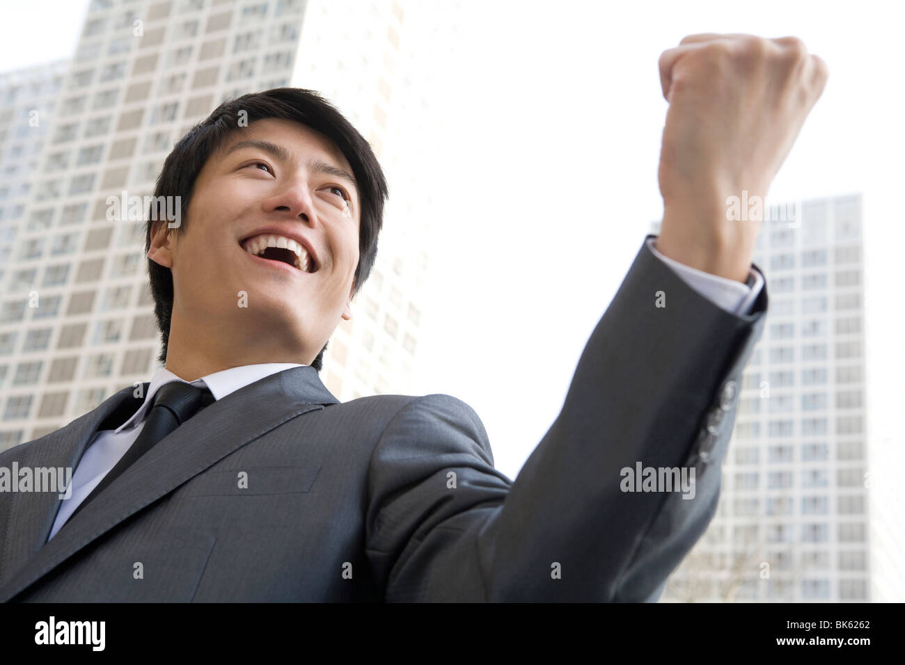 Businessman punching the air Stock Photo - Alamy