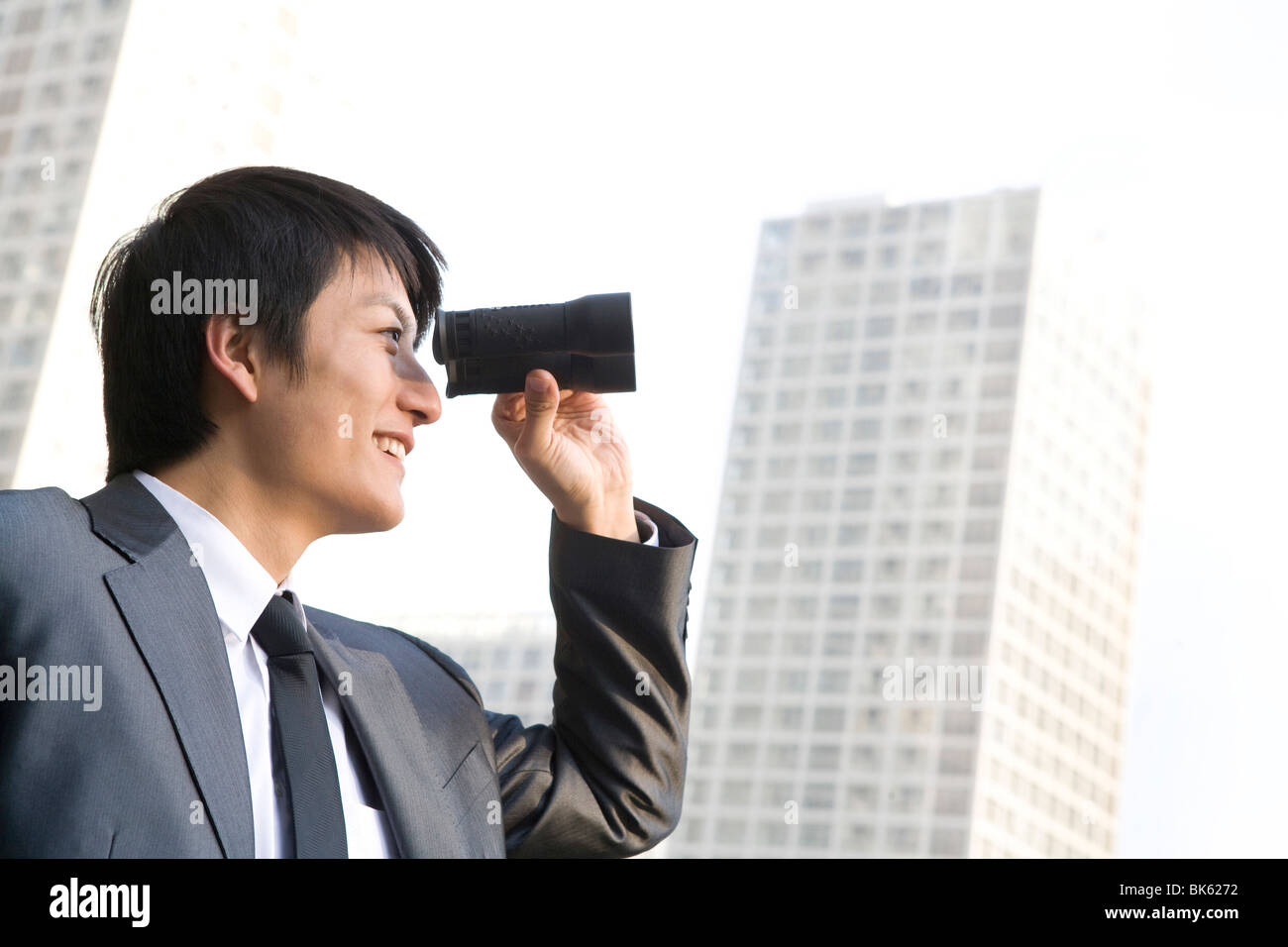 Businessman Holding Hand-Held Telescope Stock Photo - Alamy