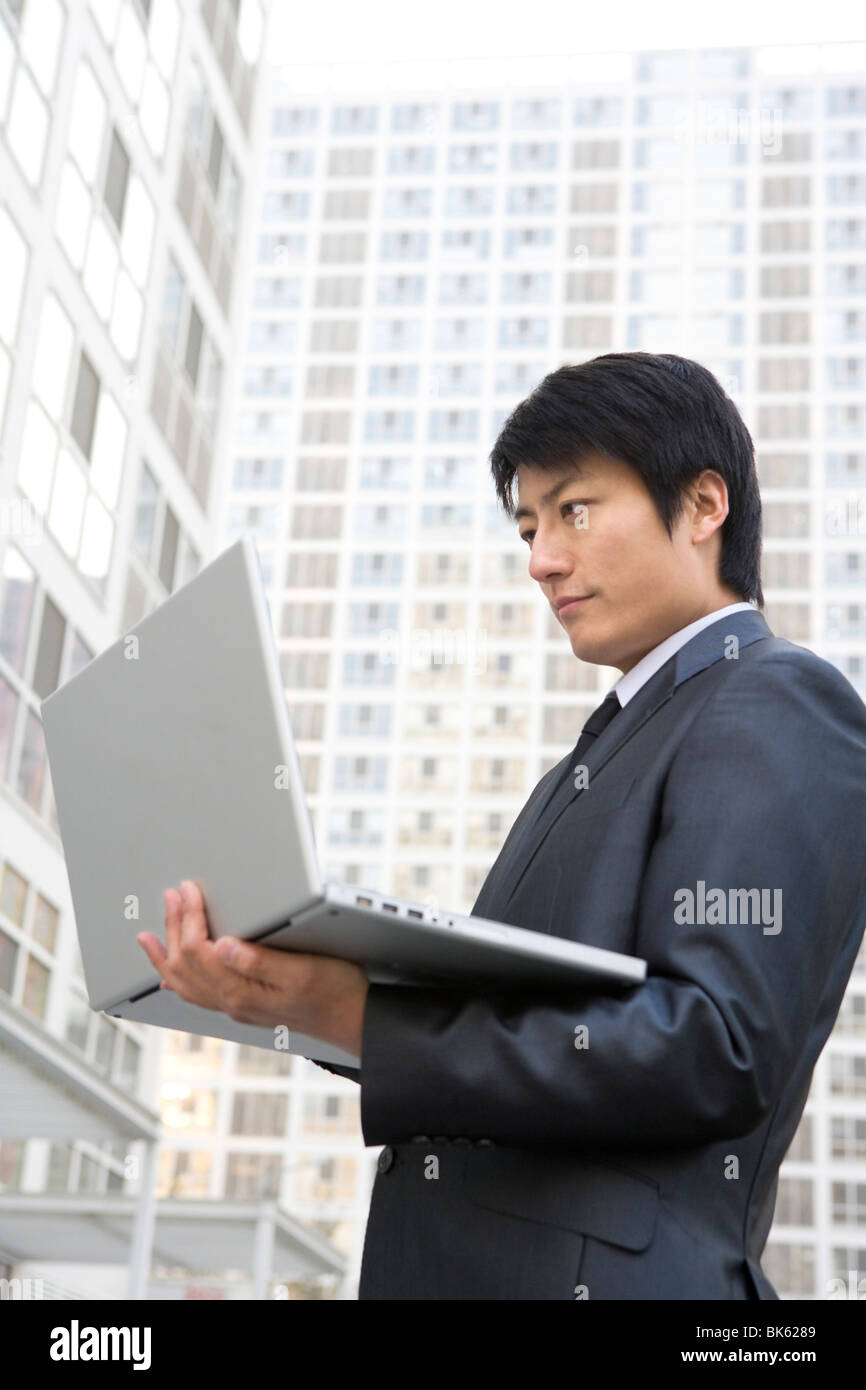 Businessman using laptop Stock Photo - Alamy