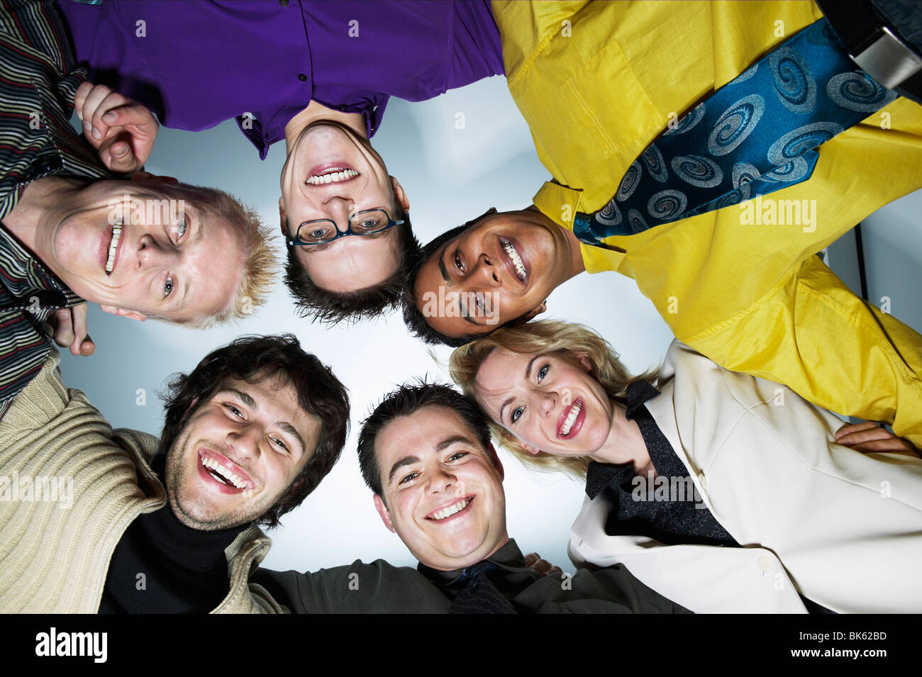 Portrait of business executives in a huddle Stock Photo - Alamy
