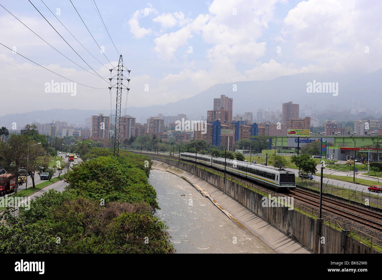 Metro overground trees river roads skyscrapers Stock Photo - Alamy