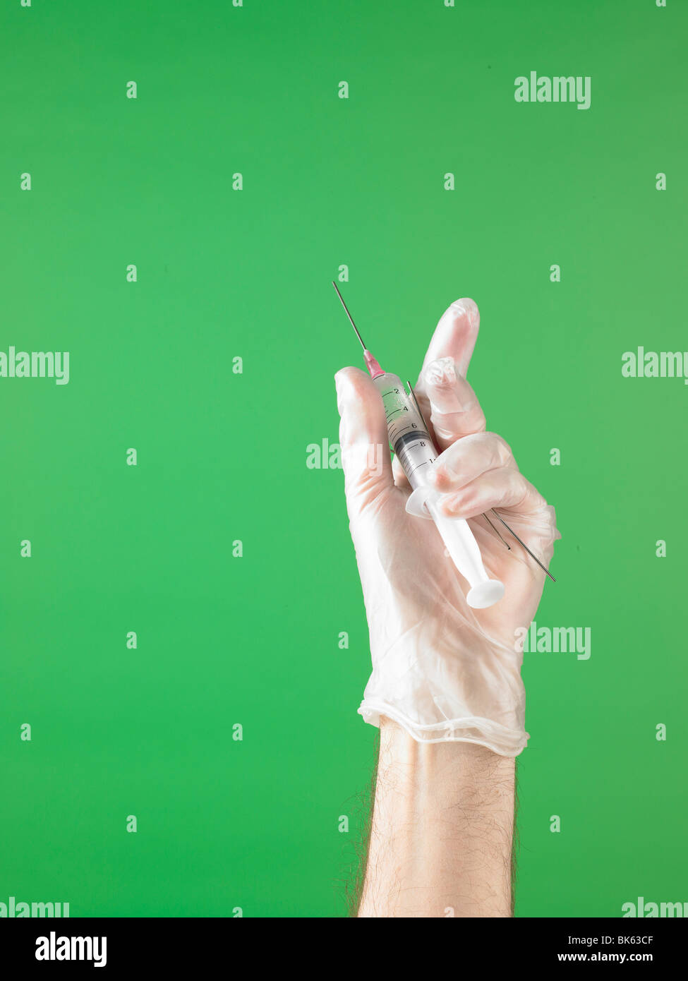 Medical gloved hand with syringe and needles Stock Photo - Alamy
