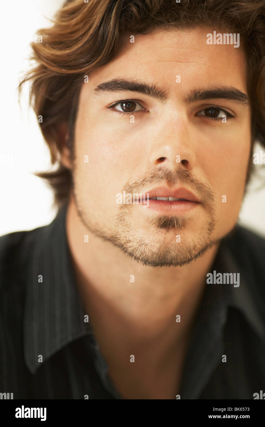 Portrait of a young man thinking Stock Photo - Alamy