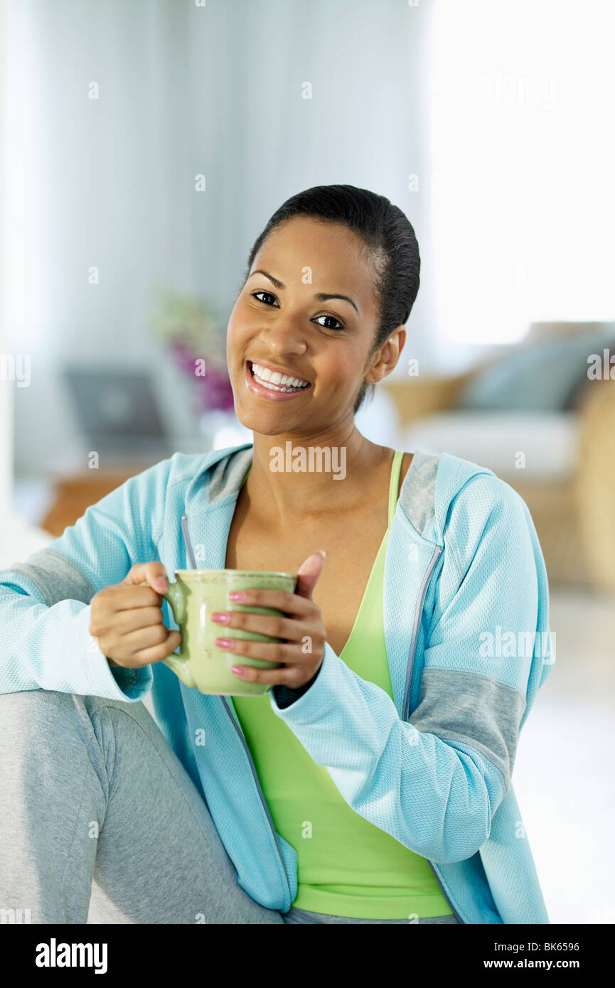 Young woman drinking coffee Stock Photo - Alamy