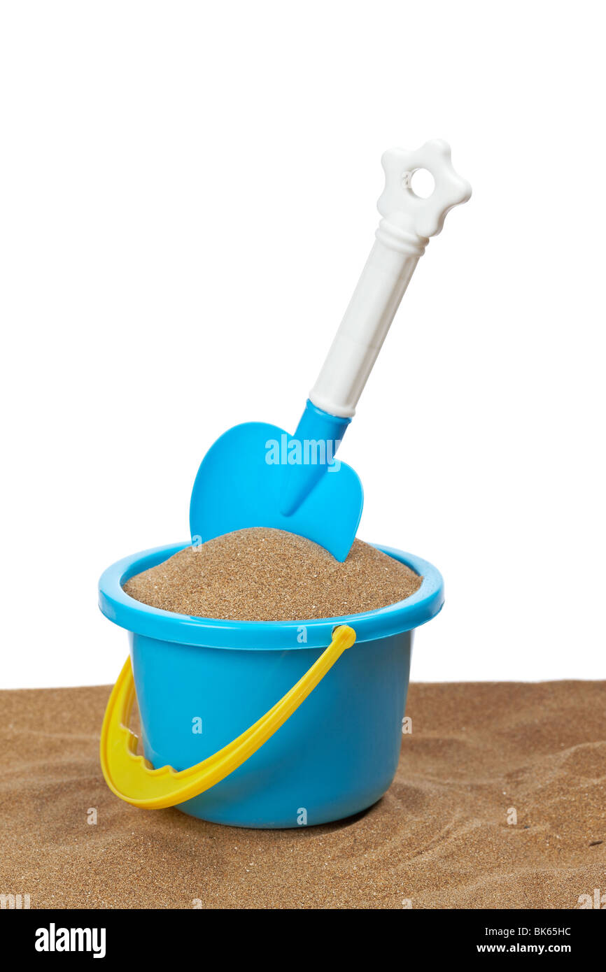 Bucket full and shovel on the sand with copy space on a white ...