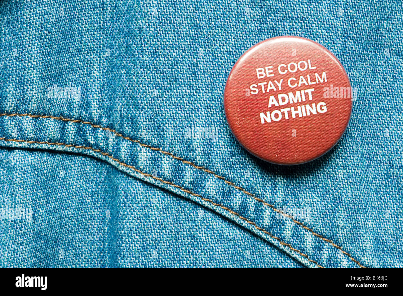 Be Cool Stay Calm Admit Nothing badge on denim jacket Stock Photo - Alamy