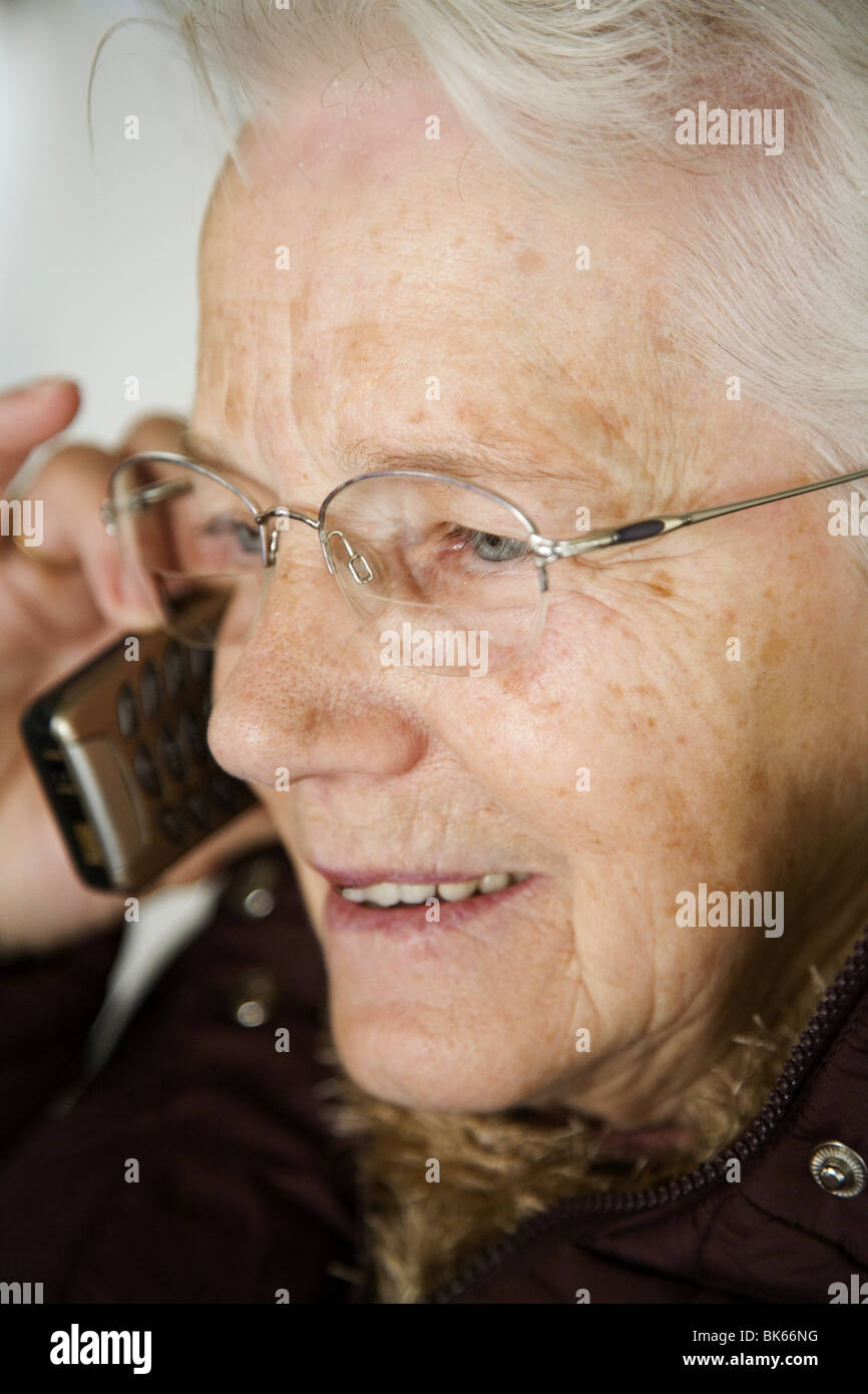 Old woman cell phone Stock Photo - Alamy