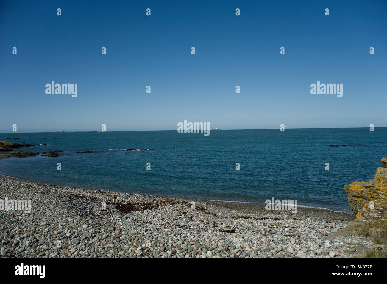 Skerries Lighthouse and beach from the Anglesey coastal path, North ...
