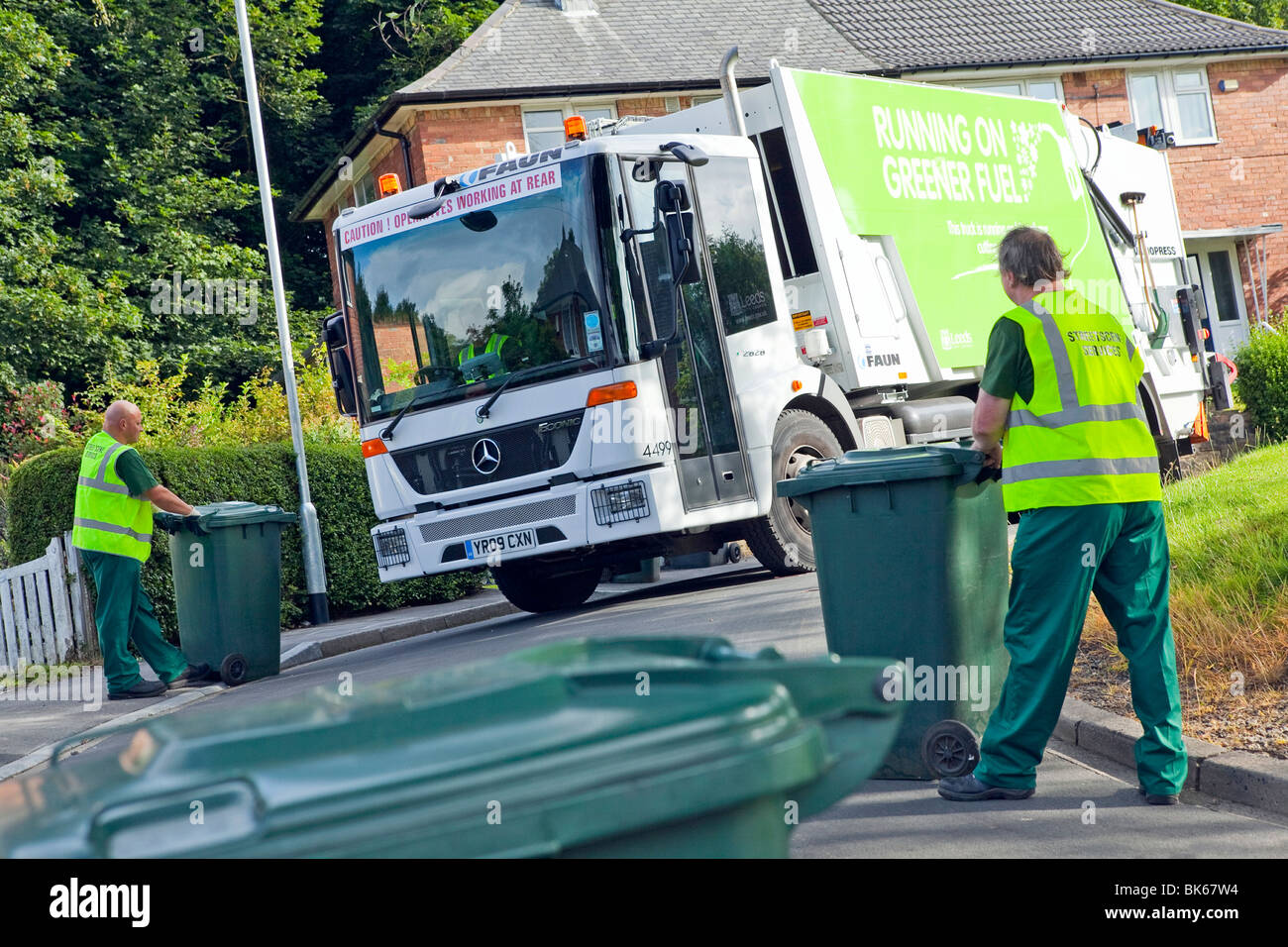 A gas powered Mercedes Econic waste collection bin lorry and bin men on ...