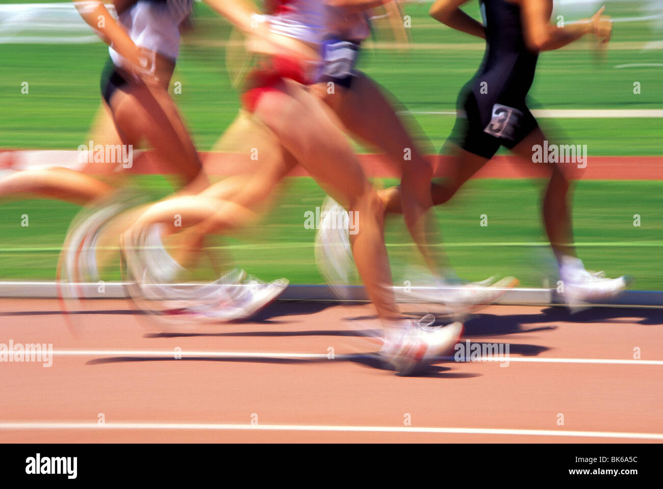 men running racers legs motion Stock Photo - Alamy