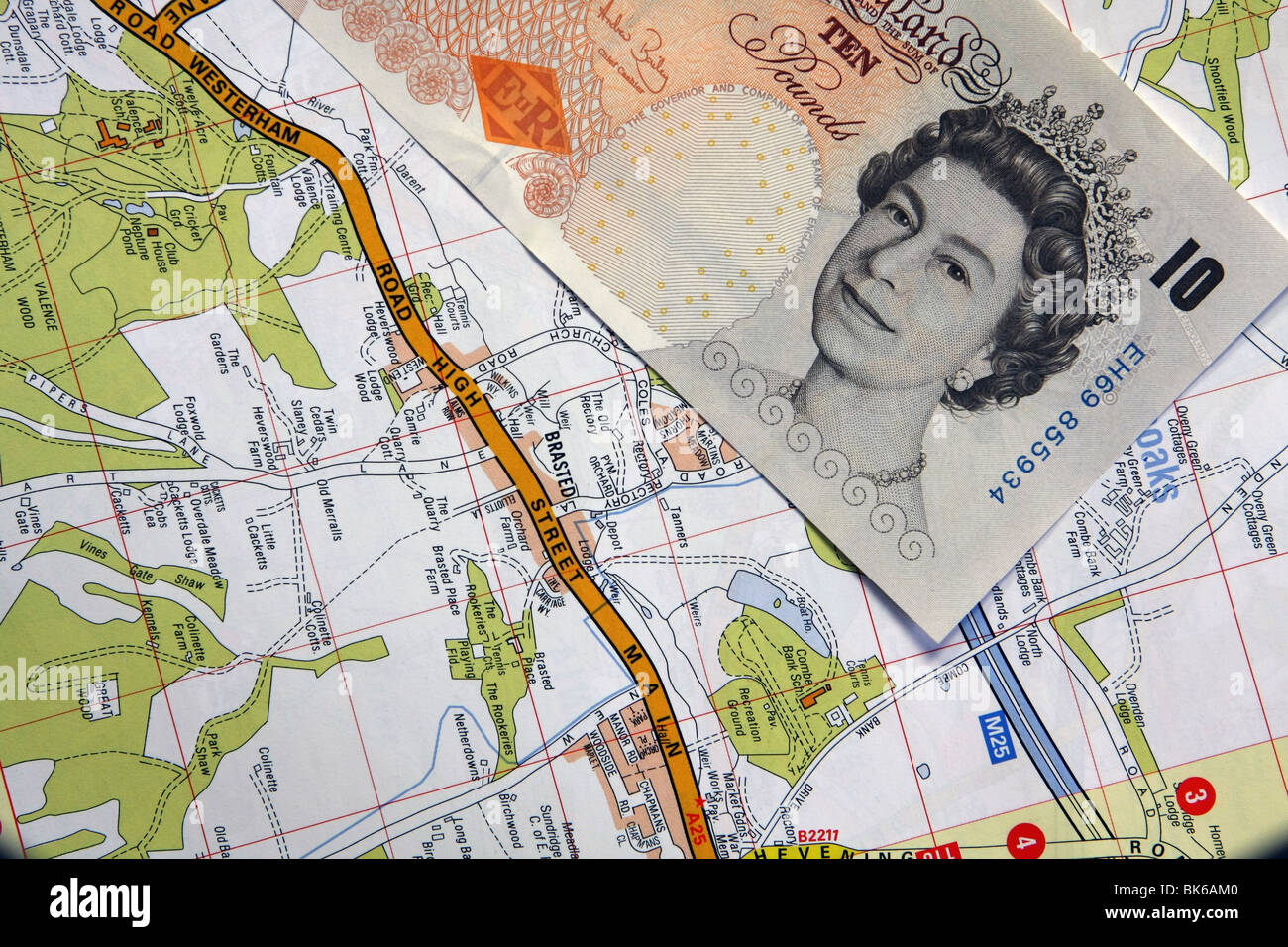 a £10 note on a page of an open road map Stock Photo - Alamy