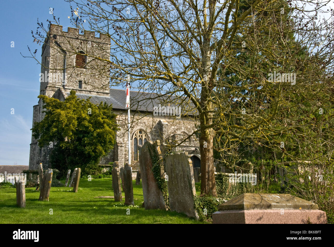 Gravestones and church in Kent Stock Photo - Alamy