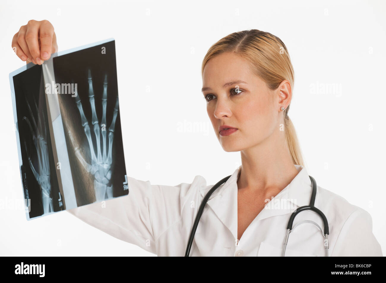 female doctor holding up x-ray with seamless background Stock Photo - Alamy