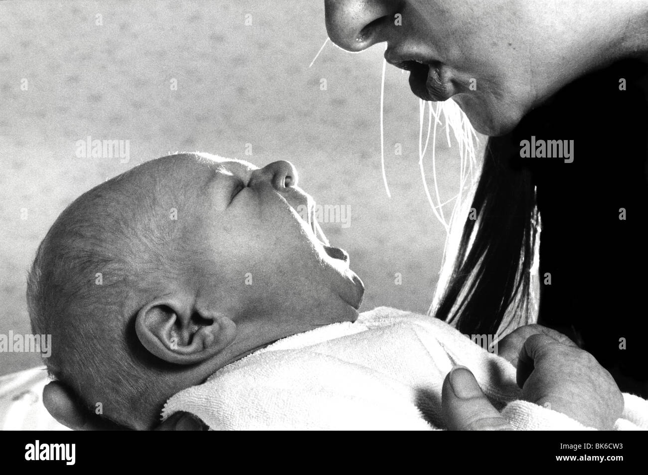 A mother tries to soothe her bawling baby Stock Photo - Alamy