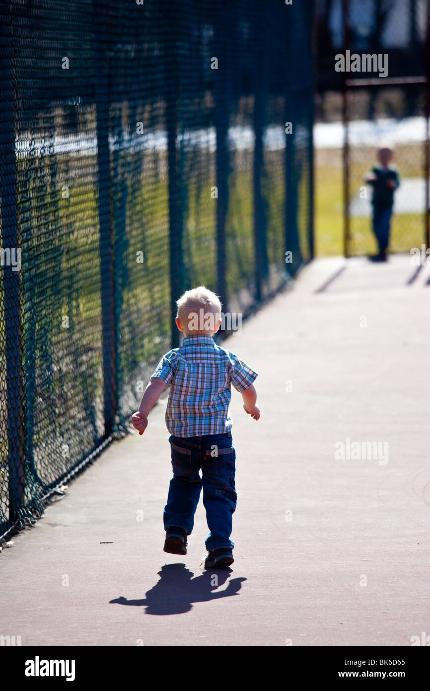 Children playing park fence hi-res stock photography and images - Alamy