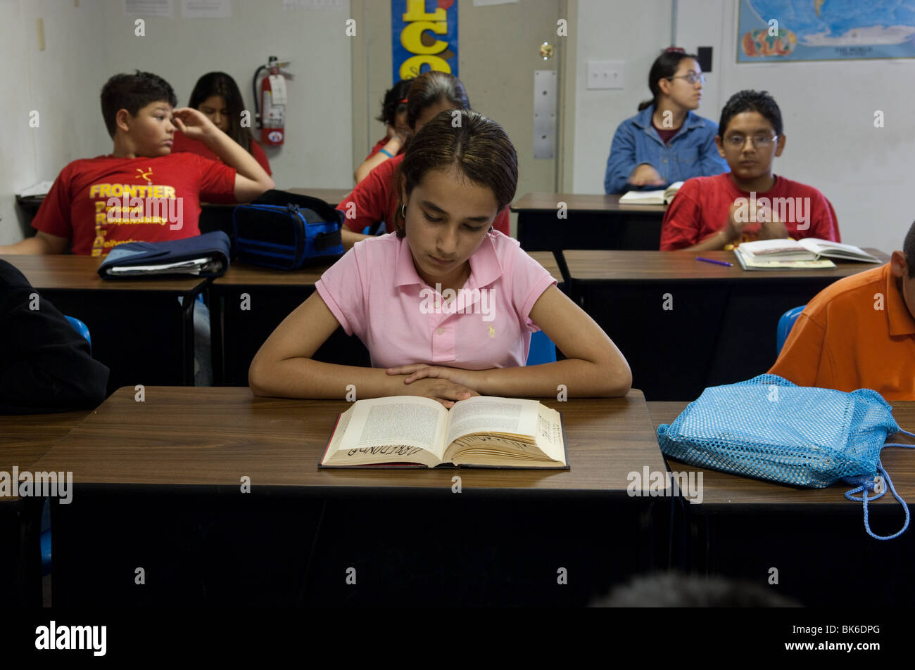 Female Hispanic high school student reads an open book in class Stock ...