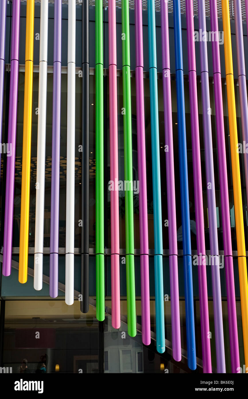 Rainbow coloured metal pipes vertical Stock Photo - Alamy