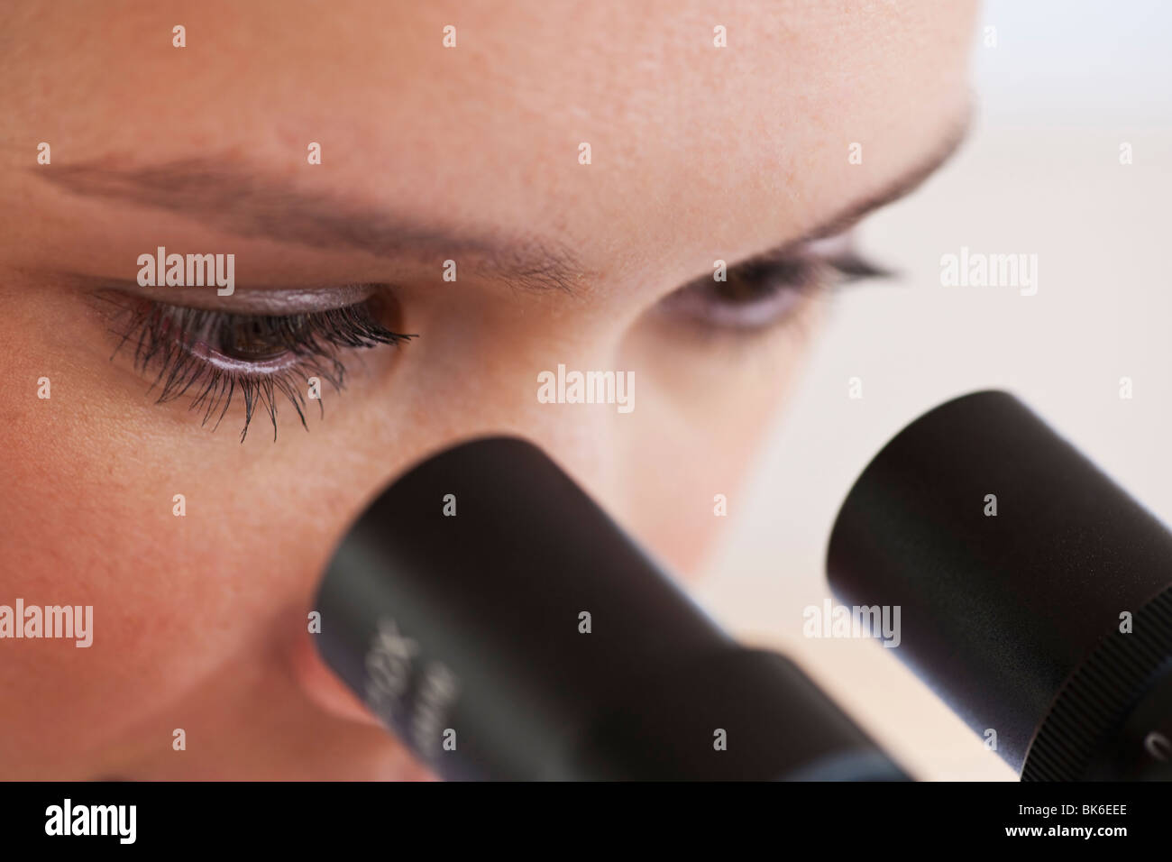 close up of woman's eyes looking through microscope Stock Photo - Alamy