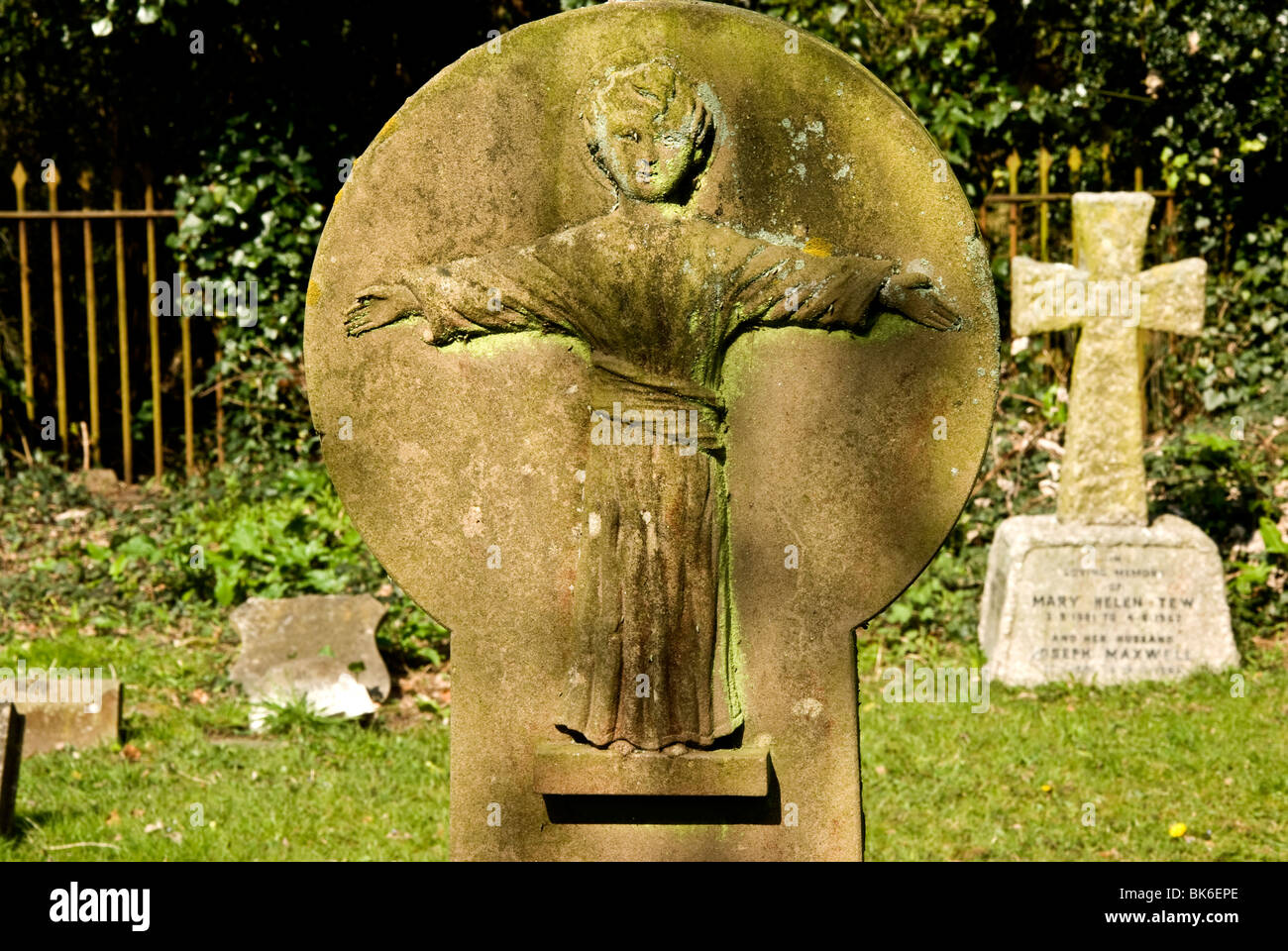 Gravestone with religious figure with outstretched arms Stock Photo - Alamy