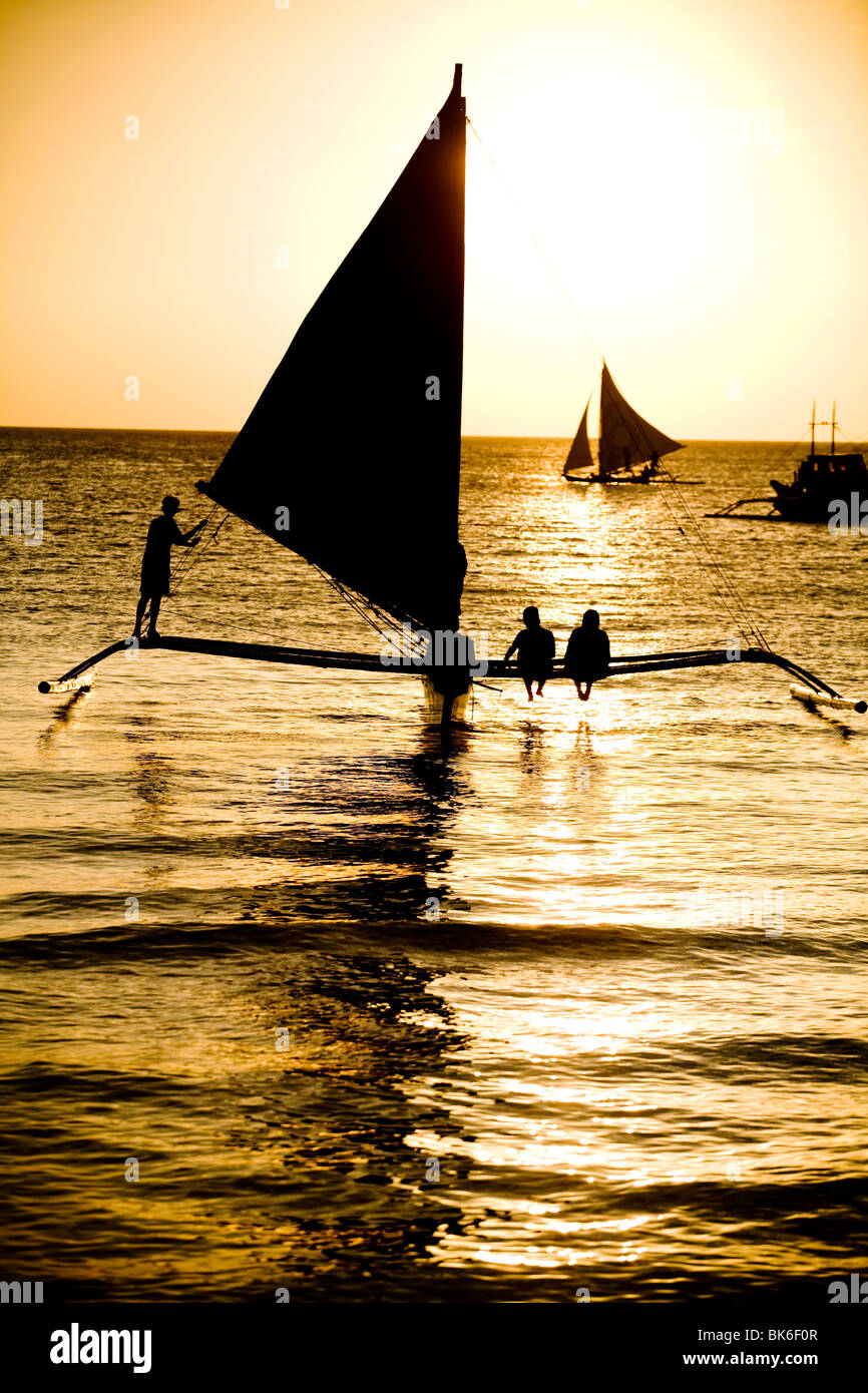 Sailboats at sunset Stock Photo - Alamy