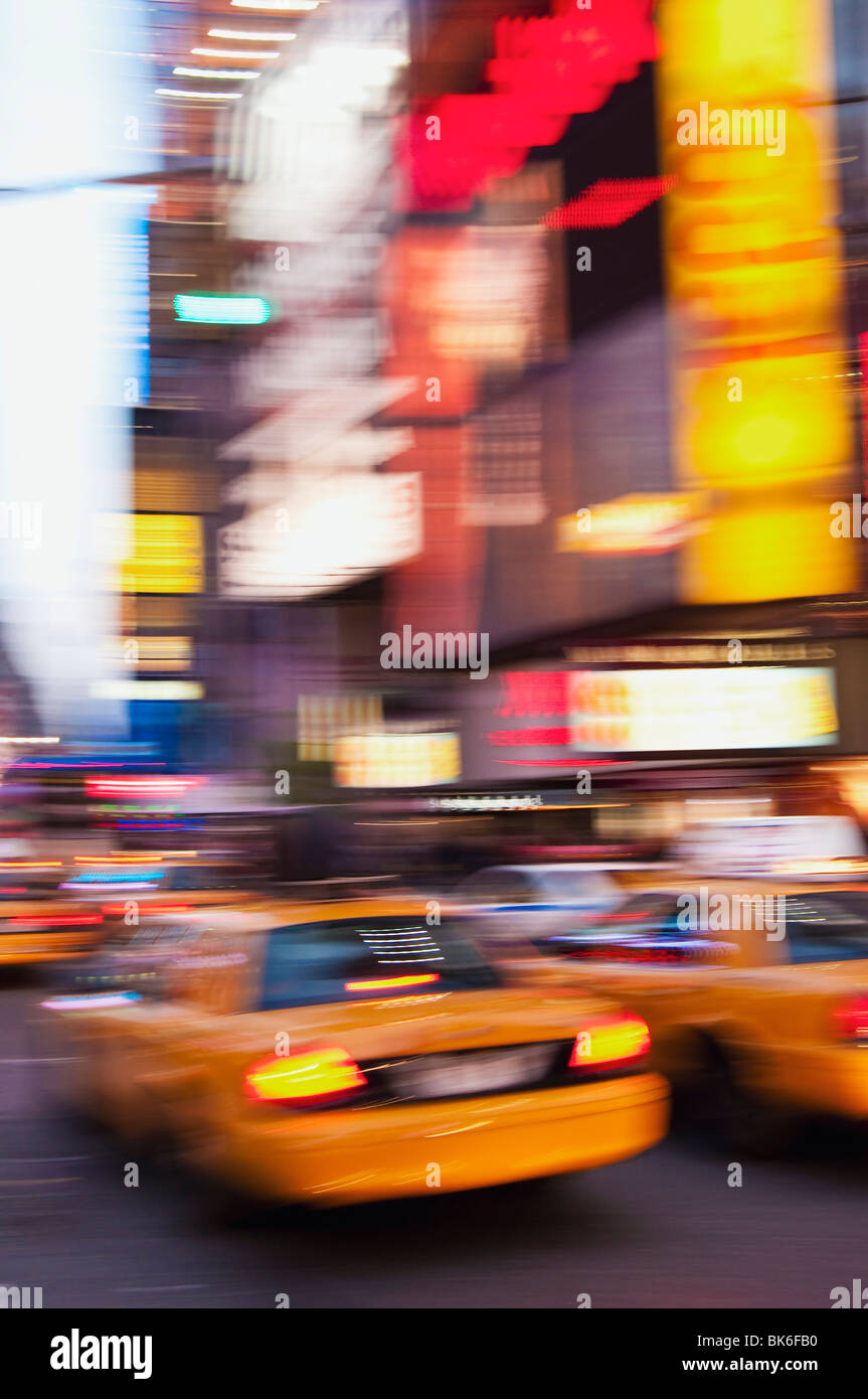 blurred photo of taxi cabs driving through Times Square Stock Photo - Alamy