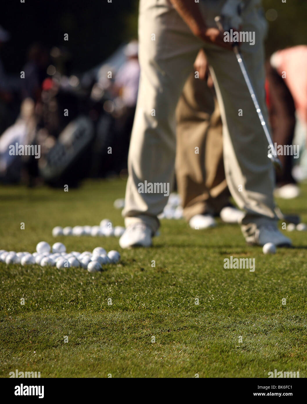 Man hits range balls at the practice area Stock Photo - Alamy