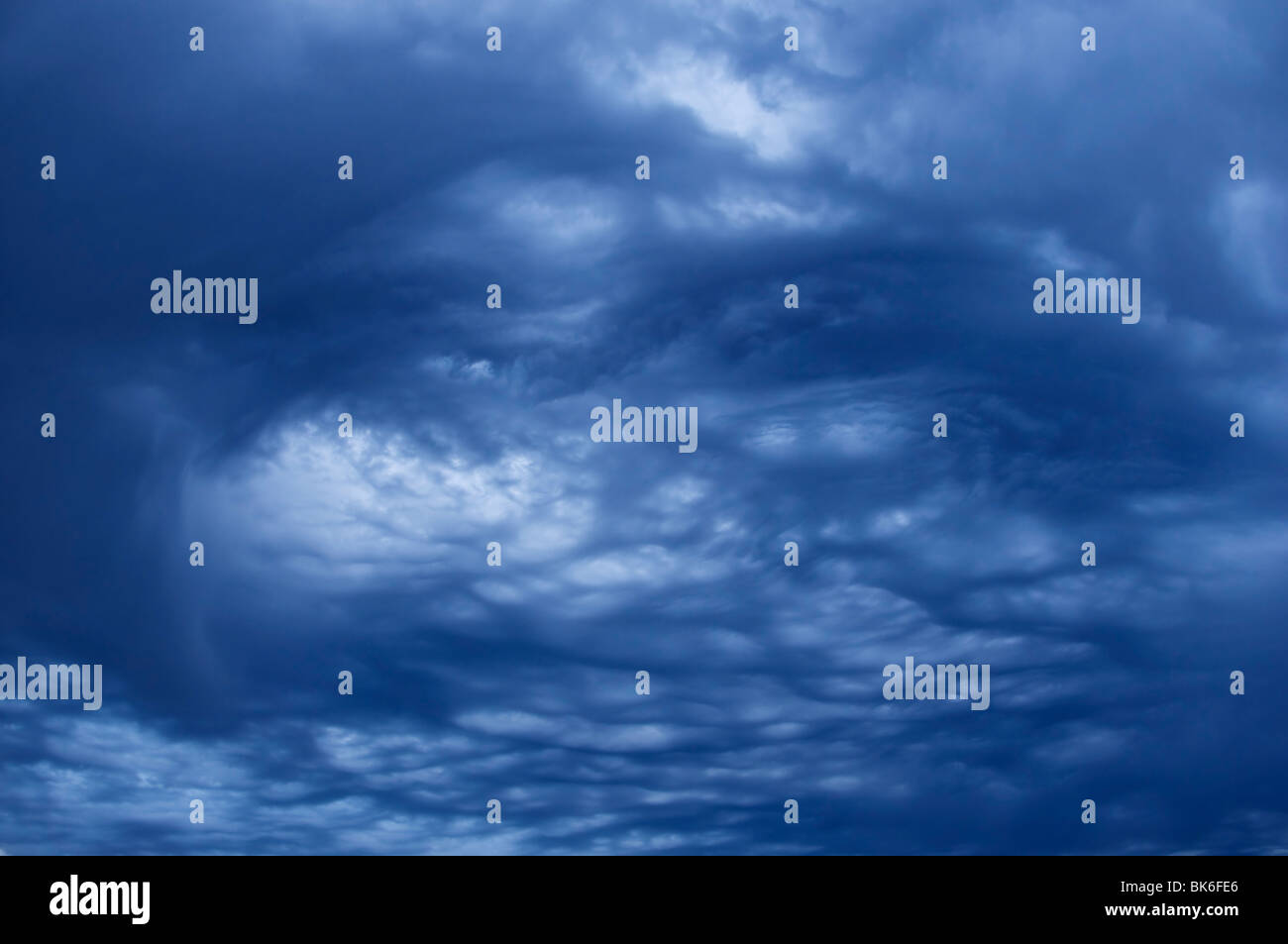 swirling blue storm clouds in sky Stock Photo - Alamy