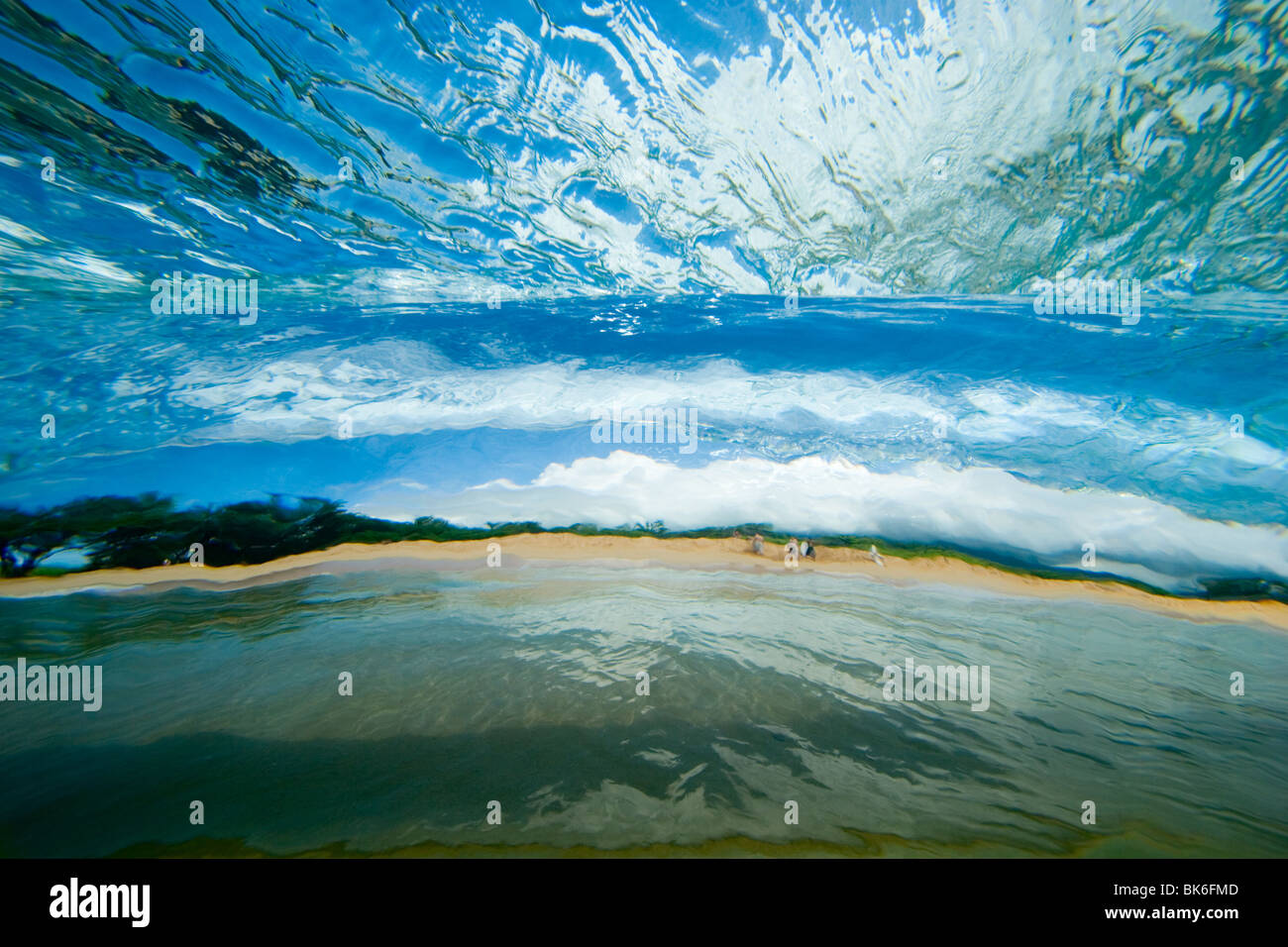 Underwater view looking through a clear wave towards the beach, with ...