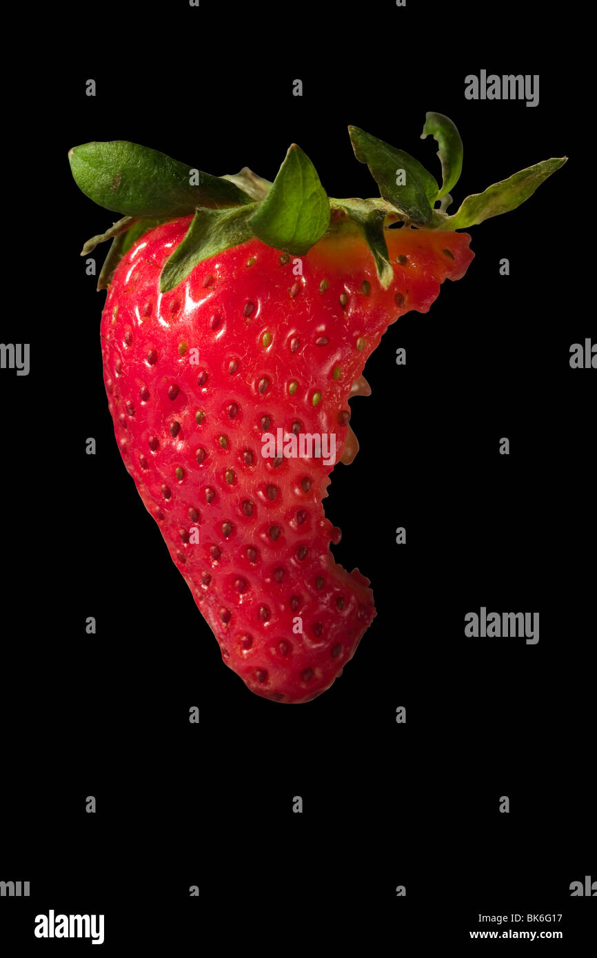 Cut Out. Strawberry with bite taken out on black background Stock Photo ...