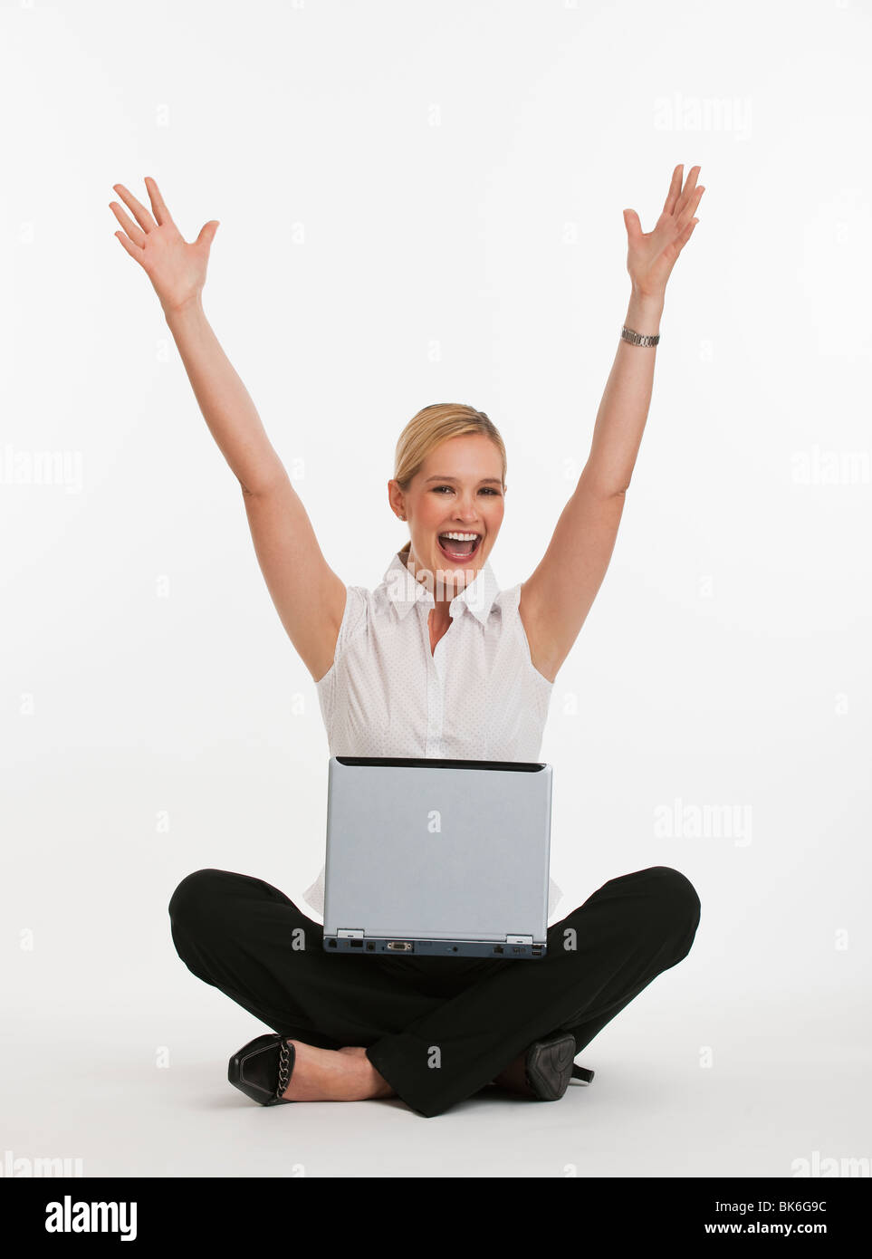 woman with arms raised excited about being on computer with white ...