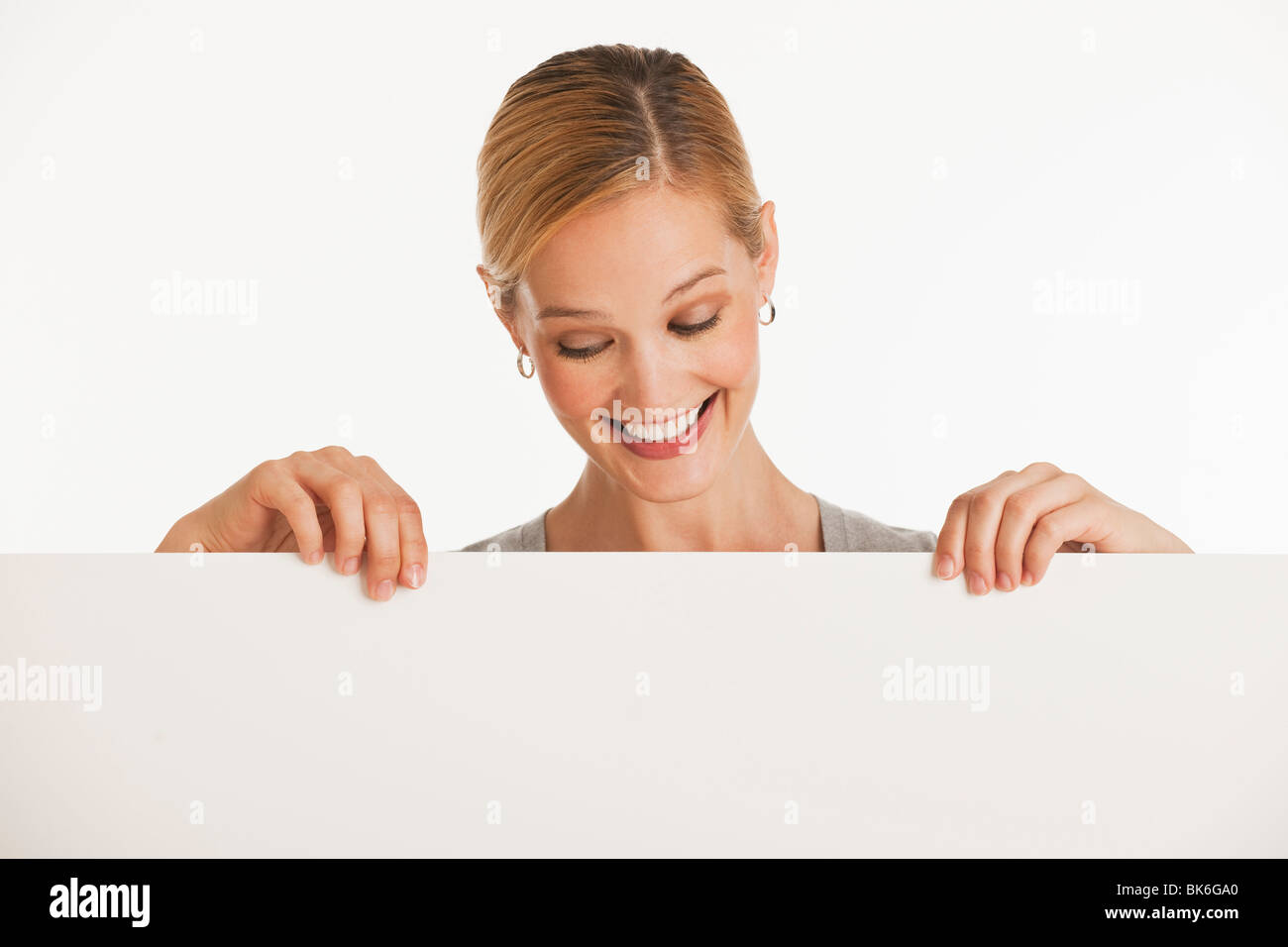 young woman holding up blank white sign for copy space use Stock Photo ...