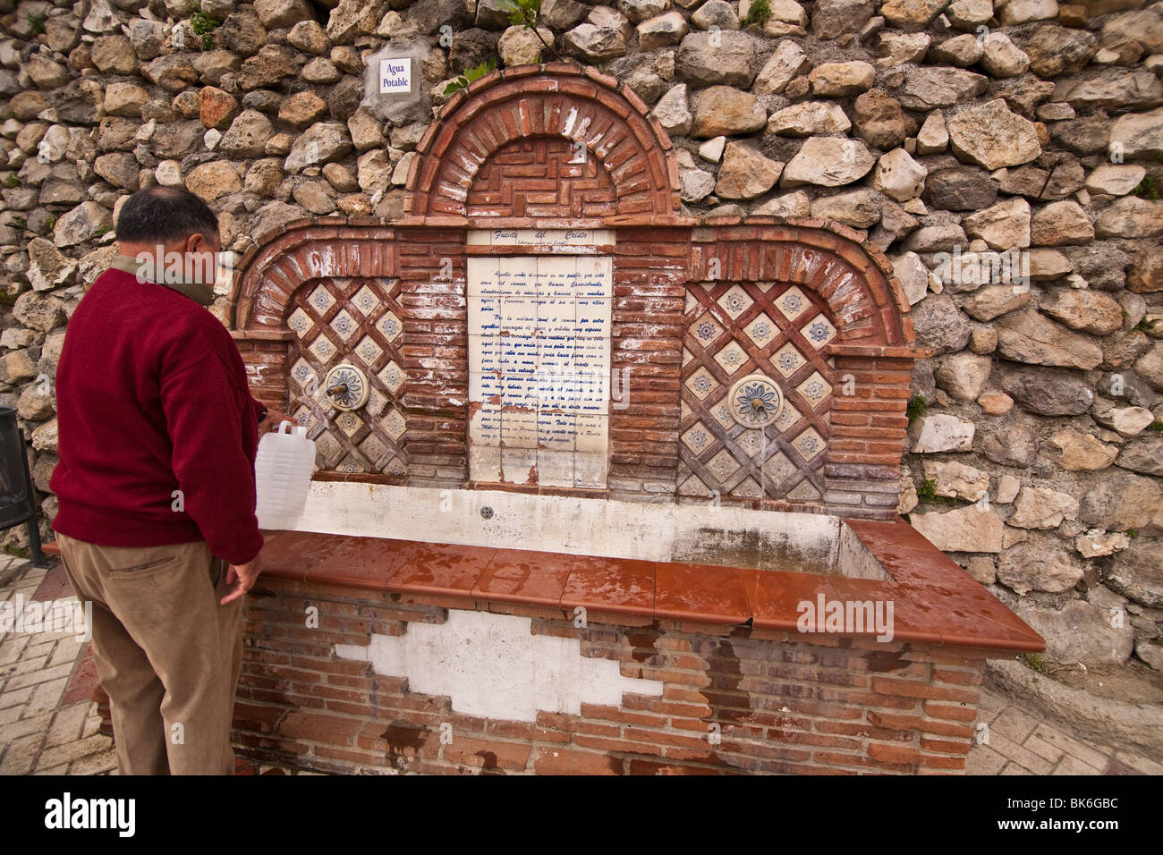 Person collecting water, Spain Stock Photo - Alamy