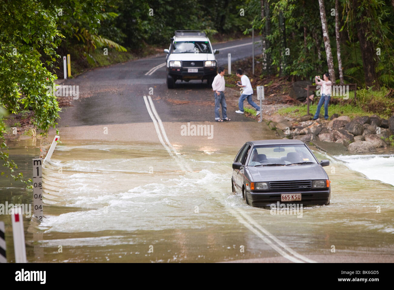 A car stuck in flood waters in the Daintree Rainforest in Queensland ...