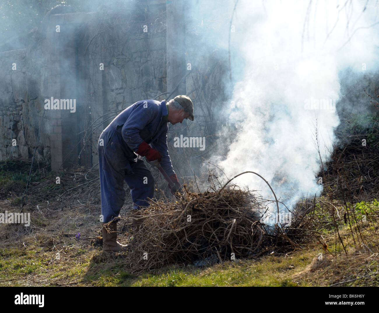 A man burning leaves Stock Photo - Alamy