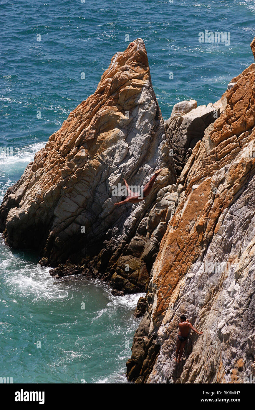 A diver does a "swan dive" off the famous cliffs of La Quebrada into ...