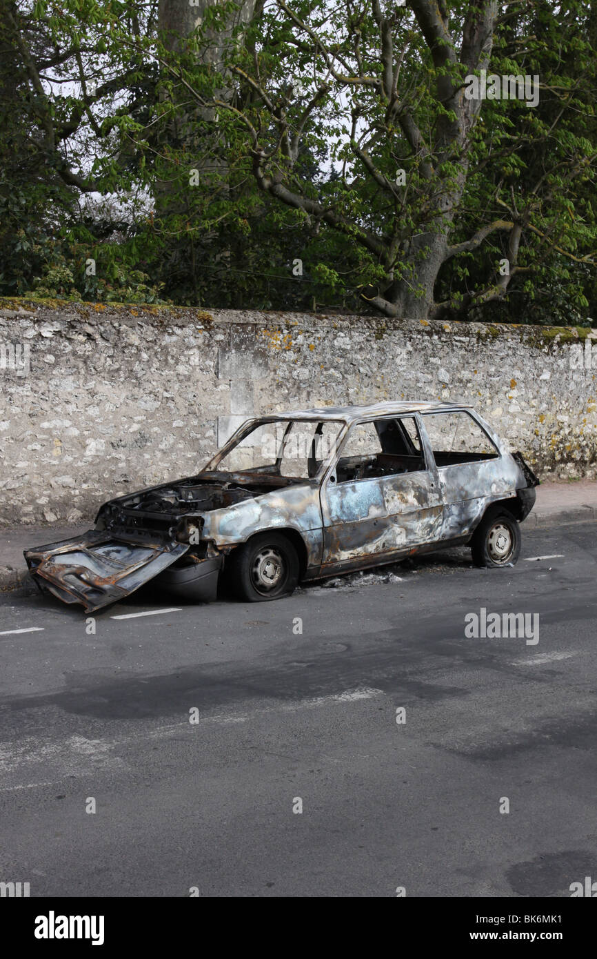 burnt out small car abandoned in road Stock Photo - Alamy