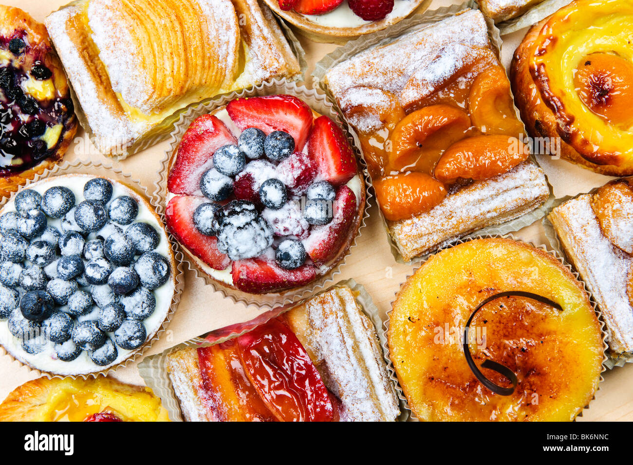 Background of assorted fresh sweet tarts and pastries from above Stock ...