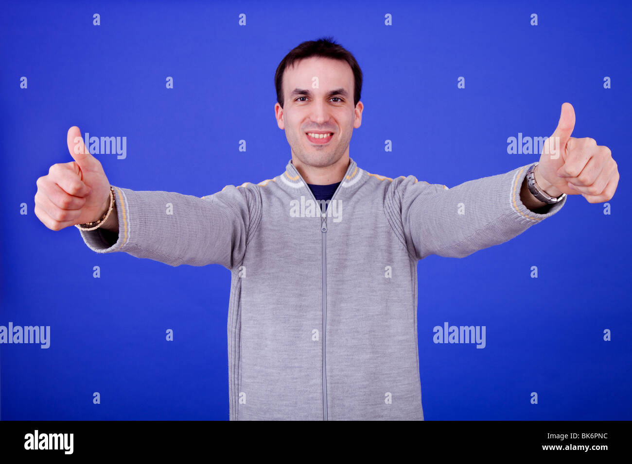 an young man portrait over a blue background Stock Photo - Alamy