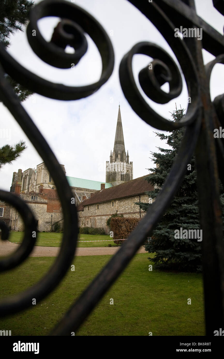 The spire of Chichester Cathedral viewed through a gate in the Bishop's ...