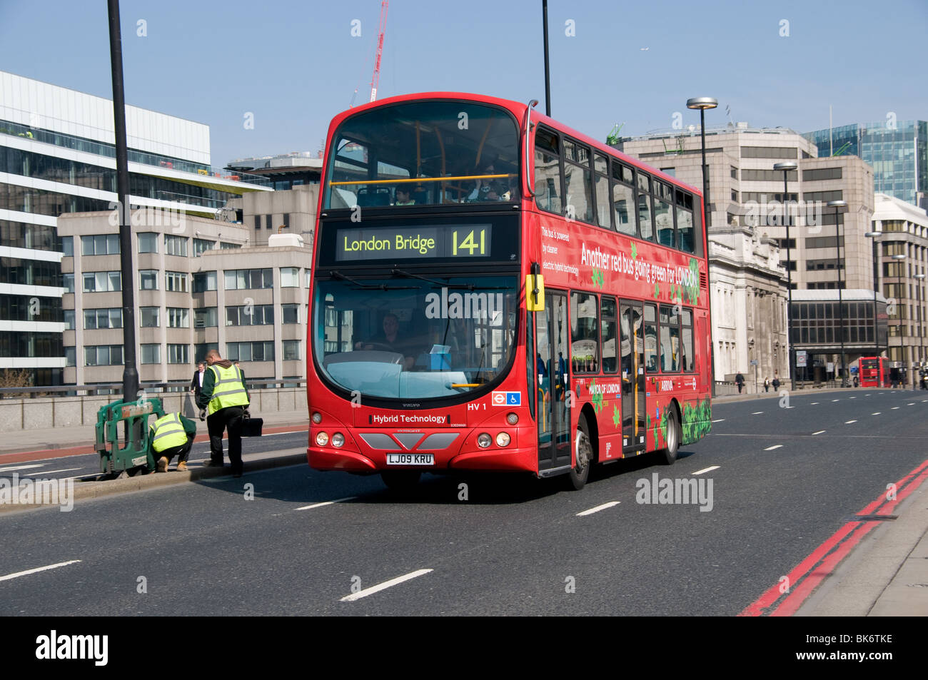A hybrid London bus crosses London bridge heading for London Bridge ...