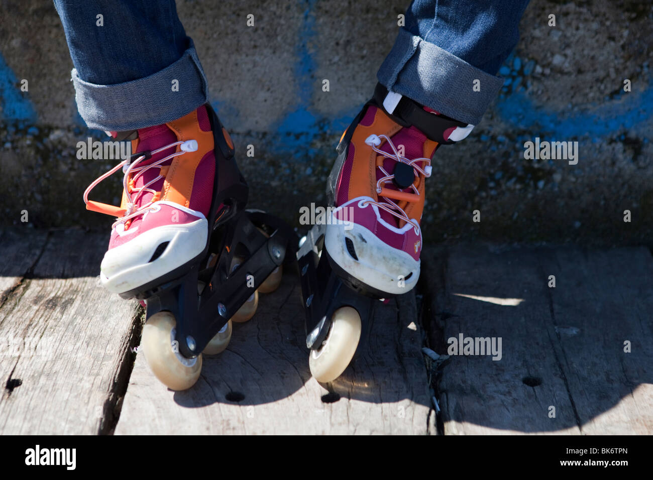 Young girl wearing colorful in line skates Stock Photo - Alamy