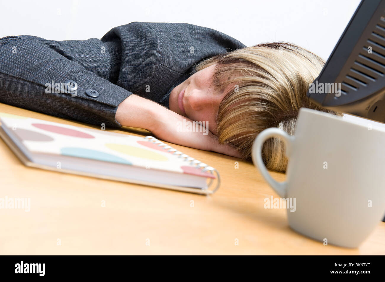 tired female office worker sleeping at desk Stock Photo - Alamy