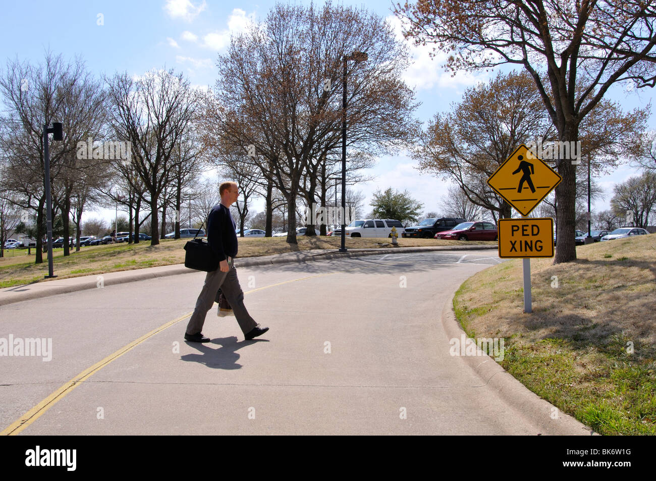 Man crossing road near the "Pedestrian Crossing" sign Stock Photo - Alamy