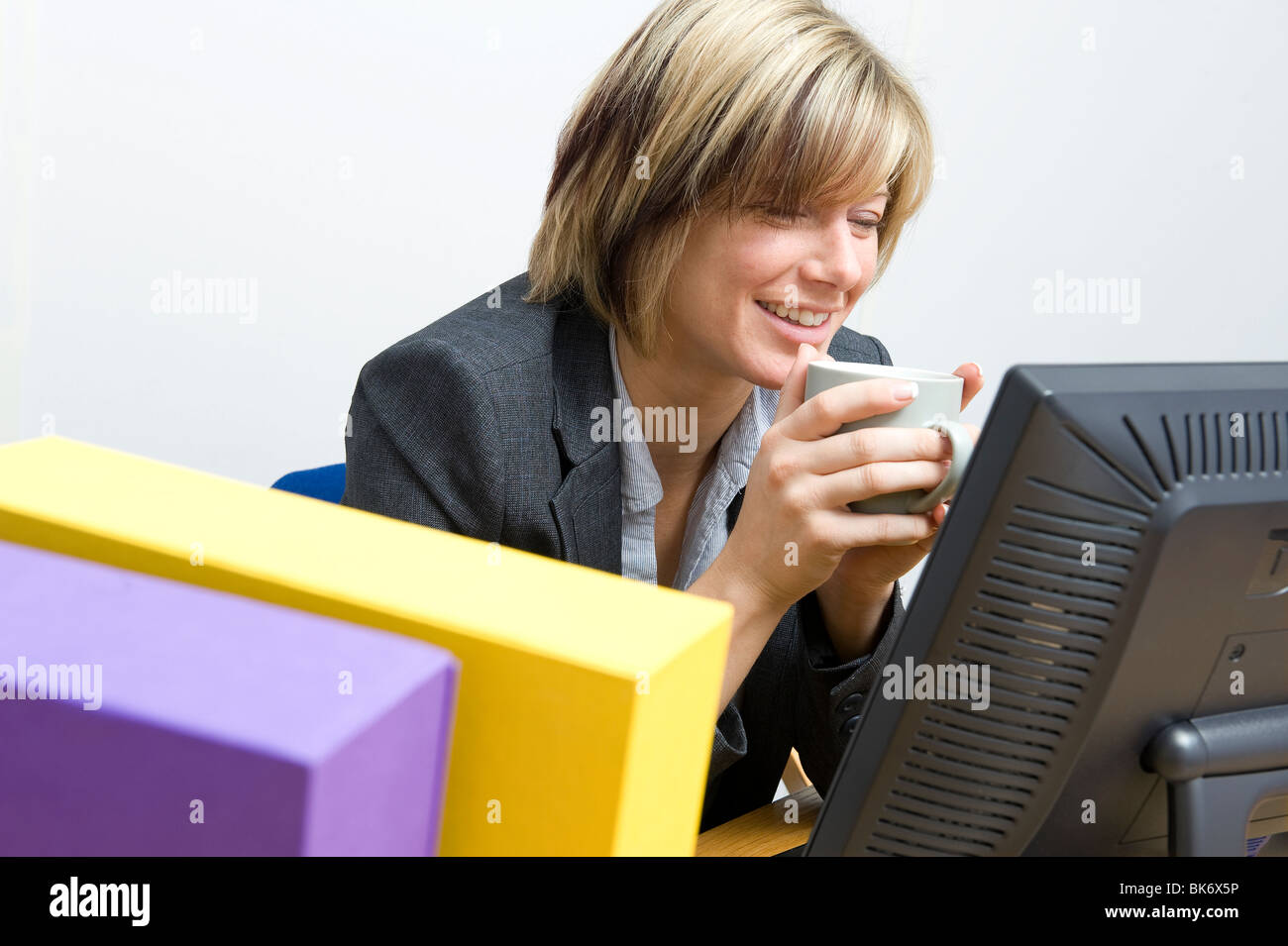 female office worker looking at computer monitor Stock Photo - Alamy