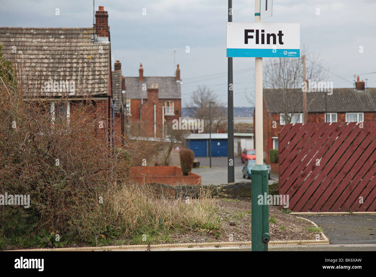 Flint railway sign with Castle Ward housing estate in background Stock ...