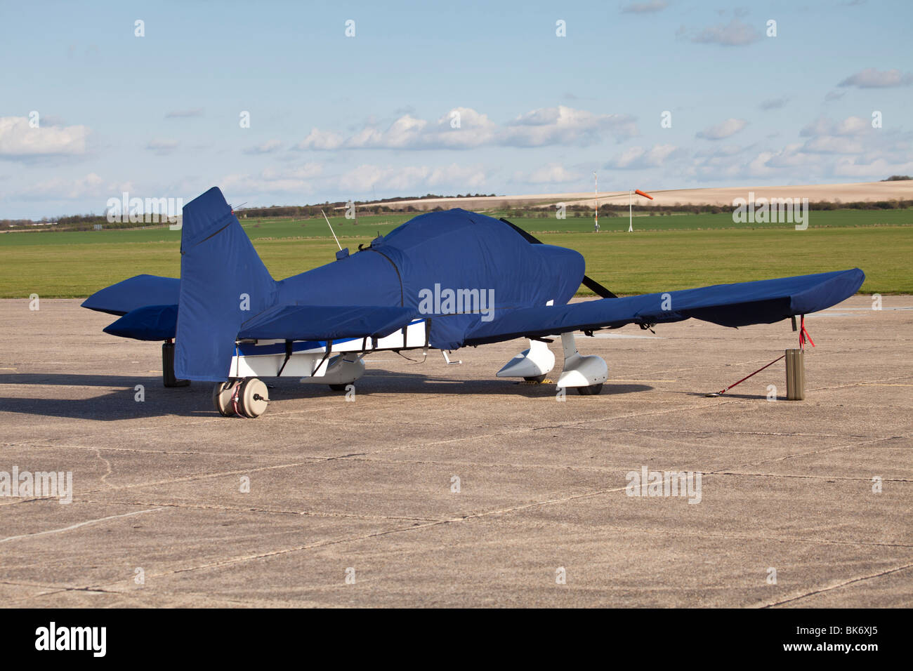 Securely wrapped and tied down light aircraft Stock Photo - Alamy