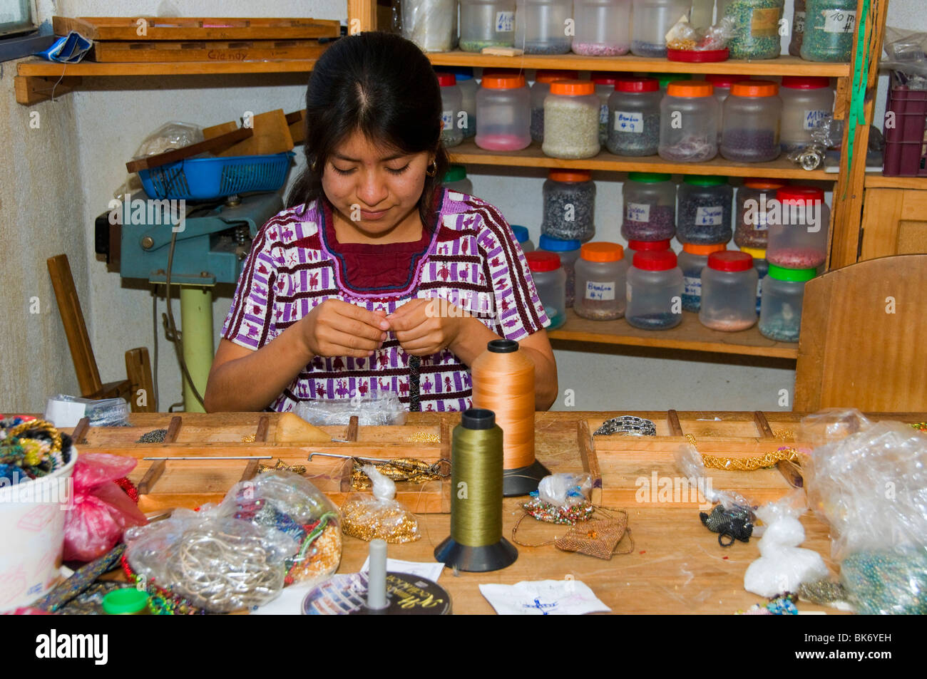 Indigenous female workers making handmade jewelery from beads Santiago ...