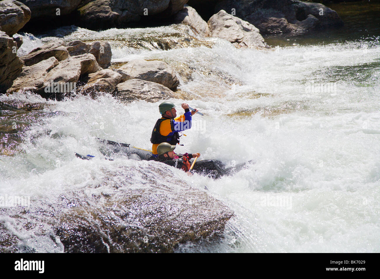 MAN AND WOMAN IN PONTOON RAFT BOAT CRASHING OVER RAPIDS BULL SLUICE ...